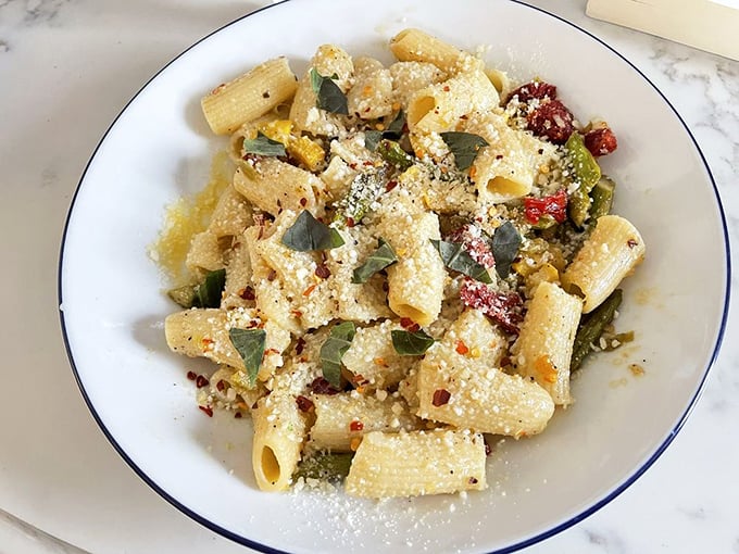 This primavera pasta isn't just a dish—it's spring captured on a plate, with rigatoni playing host to a garden party.