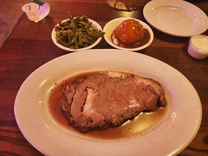 Prime rib that's been slow-roasted to pink perfection, swimming in its own savory juices—proof that Ron's Roost isn't just about the bird.