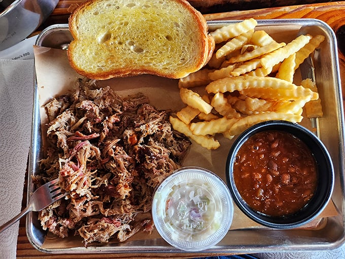 Pulled pork that's had a proper introduction to smoke before meeting your taste buds. The beans aren't just a side—they're a supporting character.
