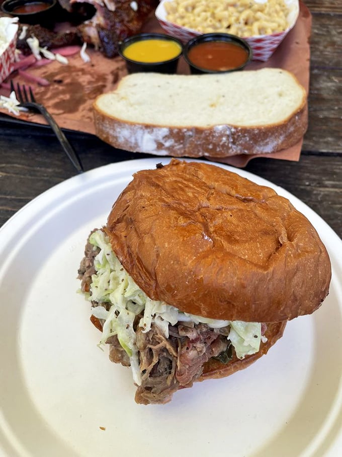 A sandwich that requires both hands and your full attention. This pulled pork masterpiece demands respect and provides pure joy.