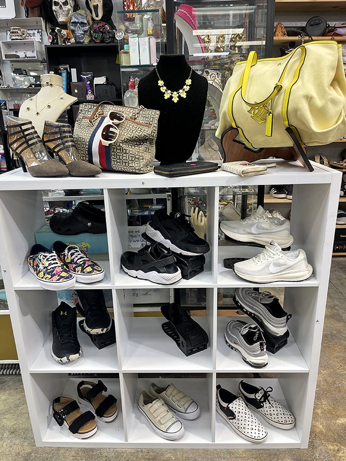 Designer dreams at thrift store prices—these cubbies showcase everything from casual kicks to evening elegance, with a few brand names hiding in plain sight.
