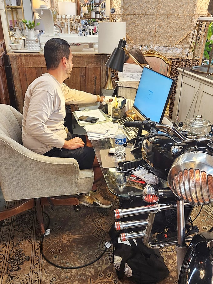 Where the magic happens—a dealer's workspace nestled among treasures. The modern computer looks almost anachronistic amid the vintage splendor.