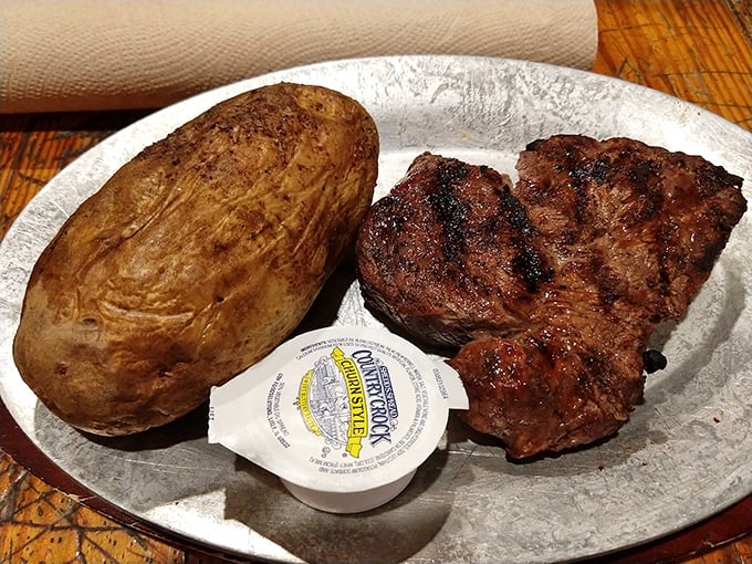 Steak perfection doesn't need fancy presentation – just a properly seared exterior, pink interior, and a potato that could feed a small family.