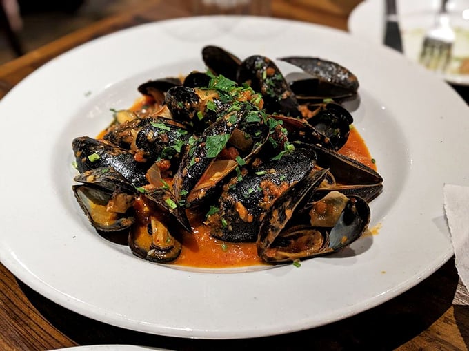 These mussels aren't just steamed—they're transformed into vessels of flavor, swimming in a sauce worthy of bread-dipping acrobatics.