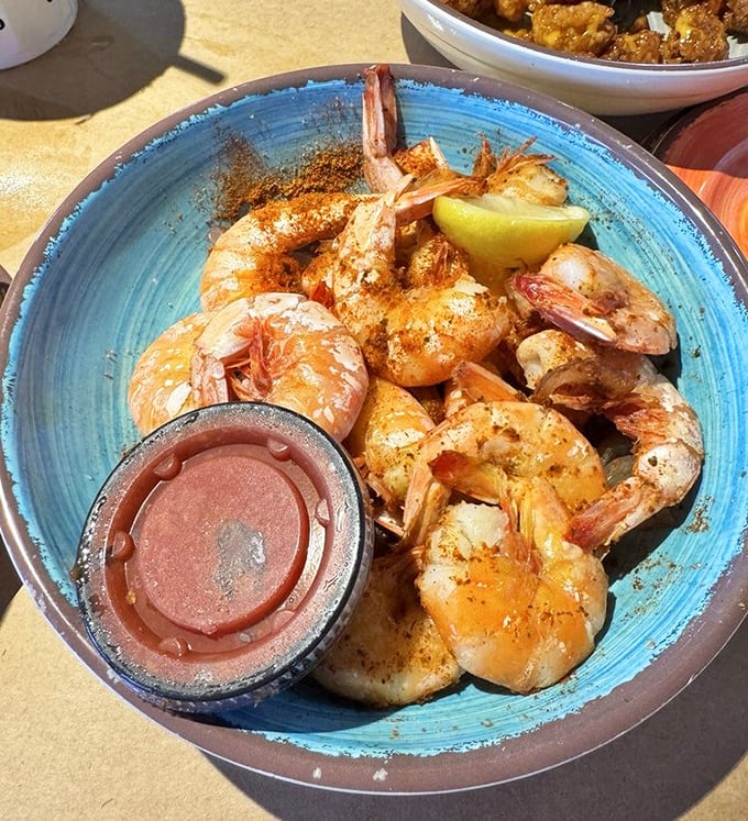 Peel-and-eat shrimp dusted with spices that would make your grandmother both blush and applaud. The lemon wedge isn't optional—it's essential chemistry.