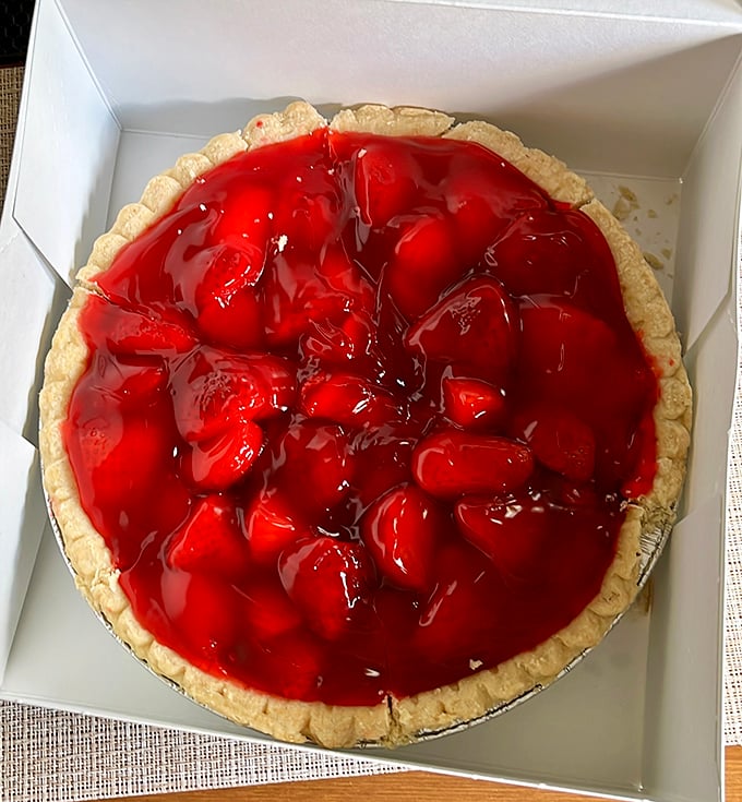 Summer captured in a crust. These strawberries aren't just berries; they're little red jewels of sunshine suspended in sweet glory.
