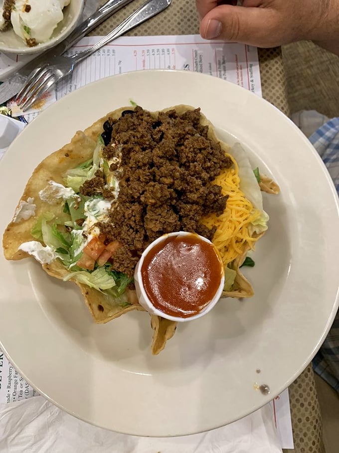 A crispy tortilla bowl cradles seasoned ground beef and fresh toppings in this satisfying Tex-Mex masterpiece.