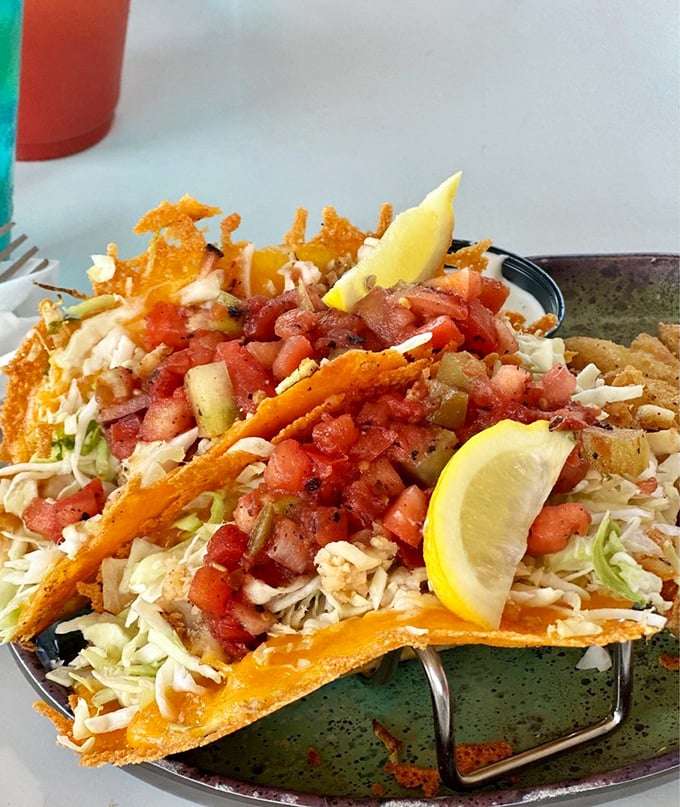 Taco architecture at its finest—where fresh cabbage, diced tomatoes, and jalapeños create a colorful skyline above perfectly seasoned protein. Edible art.