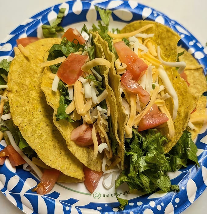 These tacos aren't trying to win awards—they're too busy winning hearts with their crispy shells, generous cheese, and that perfect lettuce-to-filling ratio.