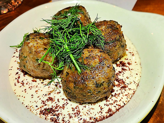 These aren't your grandmother's meatballs—unless your grandmother was a culinary genius who topped hers with fresh herbs and a silky sauce.