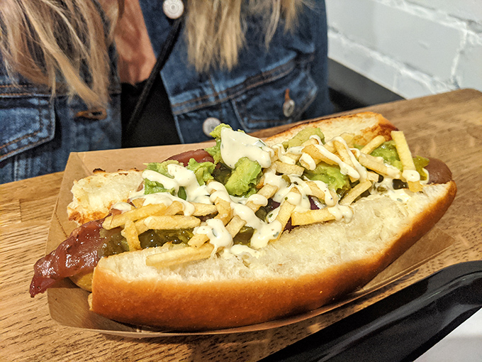 Who says vegans can't join the party? This loaded plant-based dog with its garden of toppings proves nobody needs to miss out on the fun.