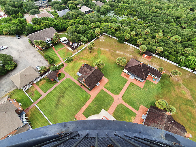 Looking down from the lighthouse gallery is like peeking at Florida's architectural yearbook—keeper's quarters and outbuildings arranged in a historical campus.