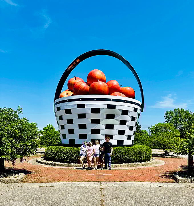 Visitors provide perfect scale reference, confirming that yes, this basket really is as enormous as it appears. Weekend road trip gold!