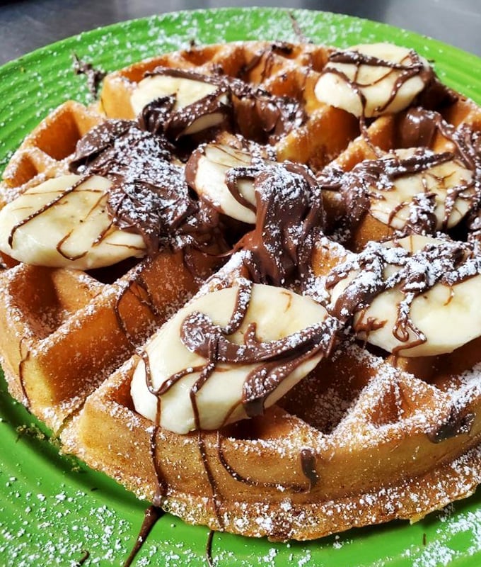 Waffles that don't waffle on flavor—crisp edges, fluffy centers, and bananas and chocolate that make breakfast feel like dessert.