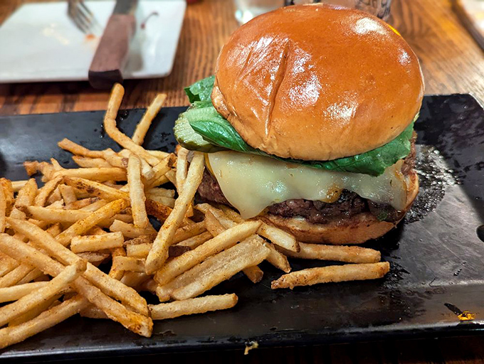 This isn't just a burger—it's a monument to beef, with melted cheese cascading down the sides like a yellow waterfall of deliciousness.