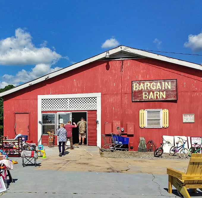 The red Bargain Barn stands proud against blue skies, promising authentic country treasures at unbeatable prices.