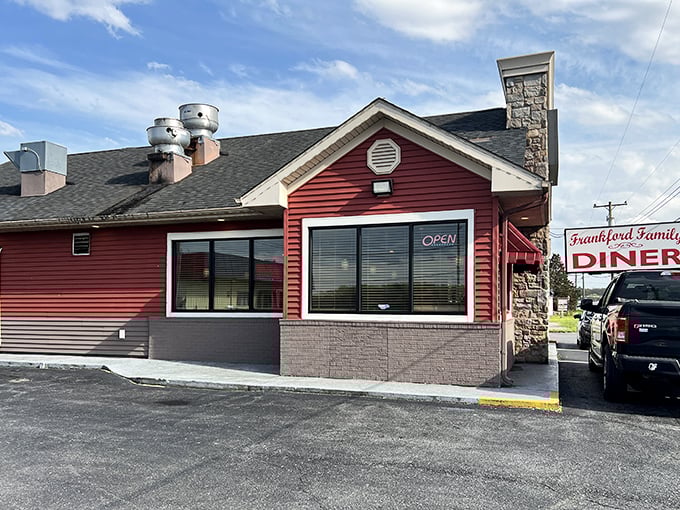 Red siding and stone chimneys create homey charm—family dining where three generations gather happily together.