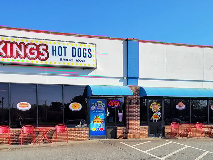 King's Hot Dogs' bright, cheerful exterior and cartoon mascot promise a royal feast. Those red chairs are thrones for hot dog royalty.