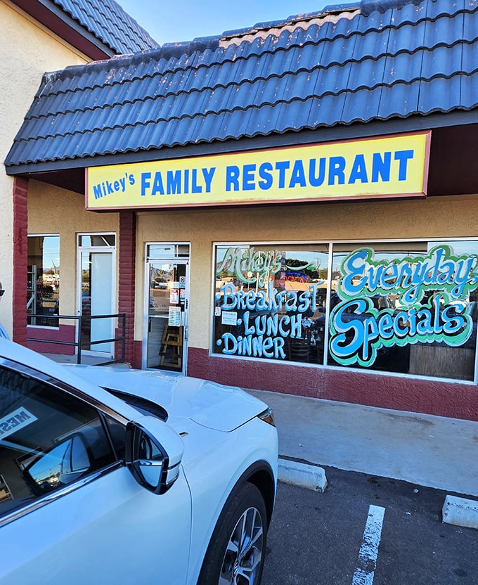 Mikey's colorful window art announces "Breakfast, Lunch, Dinner" – the holy trinity of diner delights.