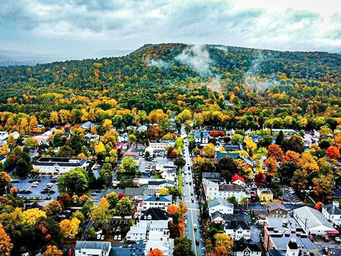Fall colors transform Milford into a painter's palette. The aerial view reveals a town nestled perfectly among nature's splendor.