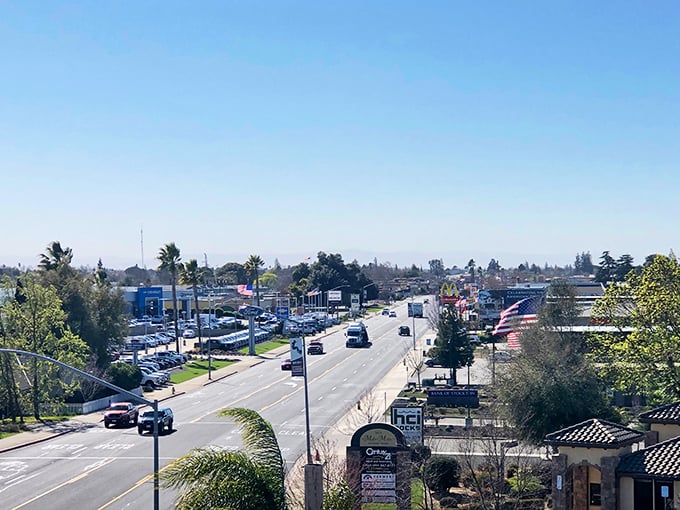 Oakdale's main drag—where the horizon stretches further than your retirement savings and golden California light makes even fast food signs look poetic.