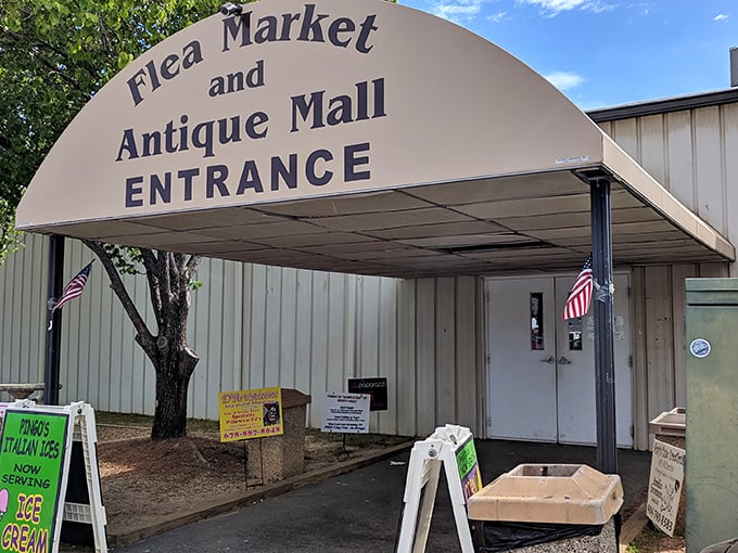 Peachtree Peddlers' welcoming awning promises air-conditioned antiquing—Georgia's perfect remedy for both empty walls and humid afternoons.