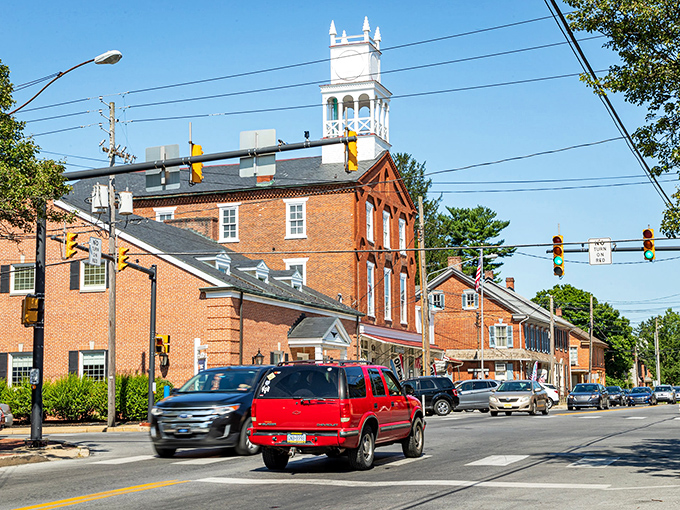 Strasburg's brick-and-steeple skyline watches over modern traffic—a town where history directs the show but lets cars have supporting roles.