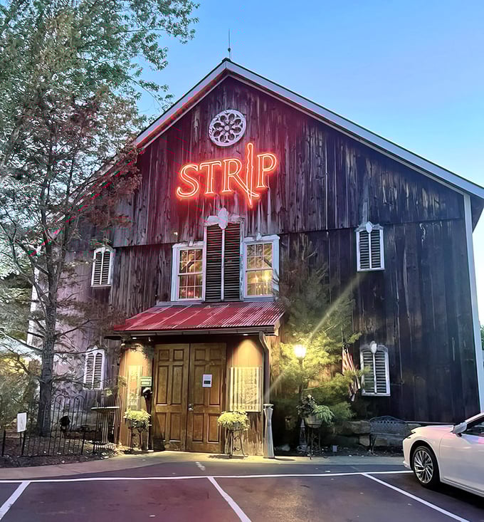 The Strip Steakhouse barn glows at dusk – part rustic time capsule, part carnivore's dream come true.
