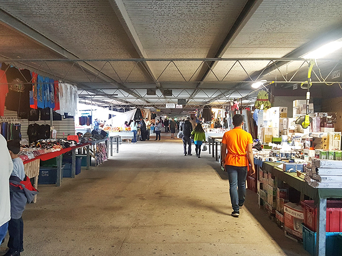 This covered aisle feels part bazaar, part block party—where bargains meet bold colors and endless people-watching.