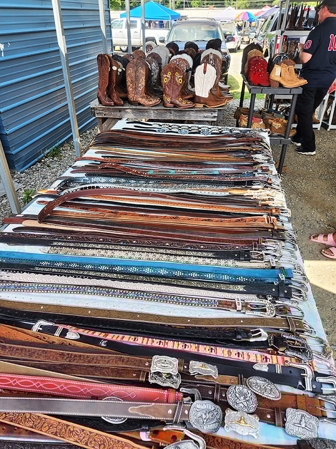 Cowboy boots and leather belts line this vendor's display – the perfect spot for Western wear enthusiasts.