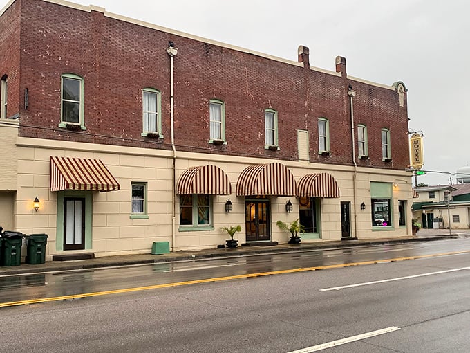 Step right in—this classic brick-and-awning beauty feels like the set of a small-town movie you actually want to live in.