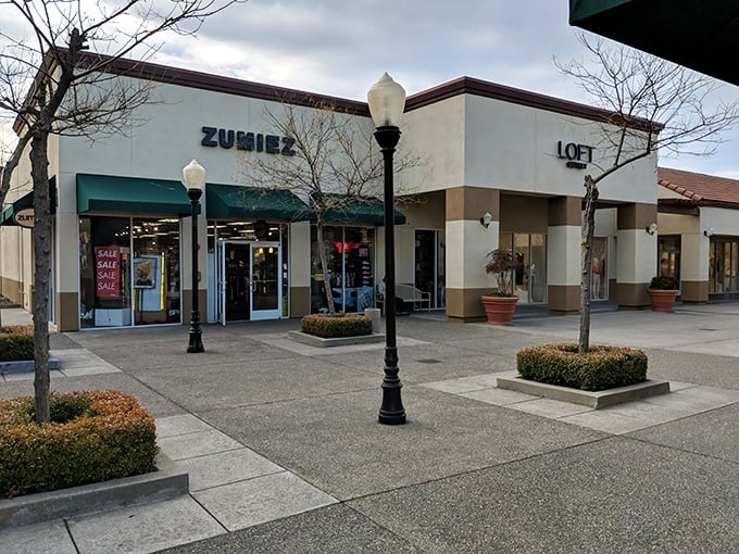 Tree-lined paths create a park-like atmosphere where Northern California charm meets serious outlet shopping power.
