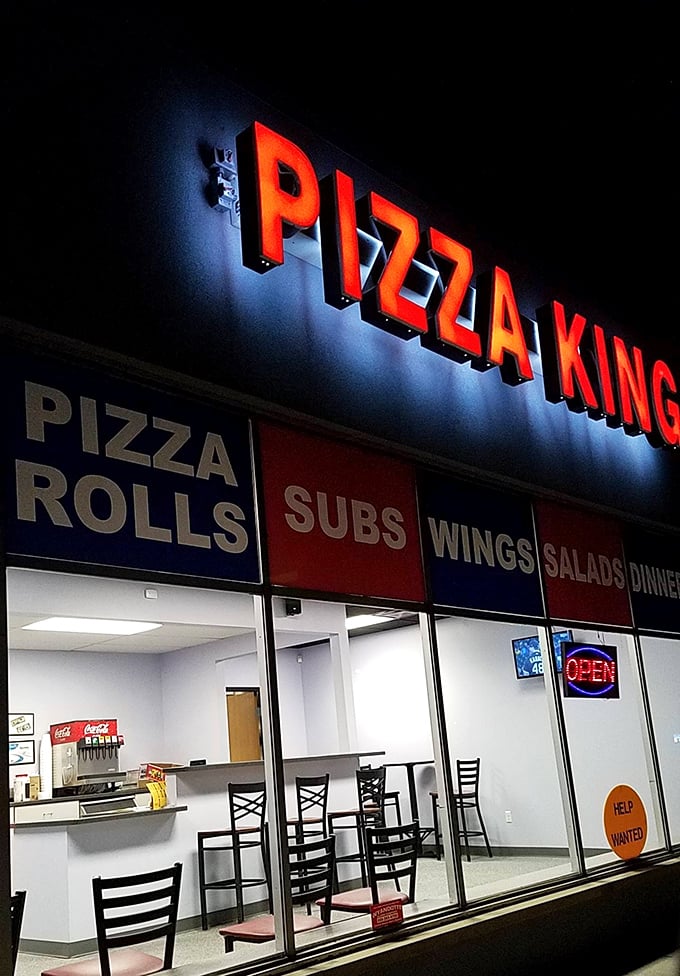 The illuminated storefront creates an inviting glow that draws pizza pilgrims from across the Detroit metro area.
