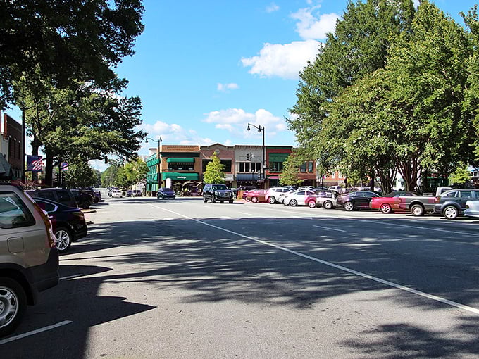 Marietta's main drag: where cars park beneath a canopy of Georgia green! Small-town charm with big-city shopping options—Mayberry meets "Project Runway."