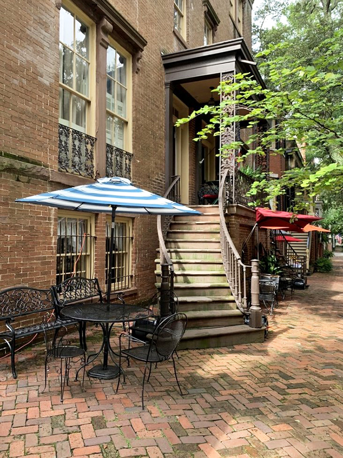 The charming outdoor seating at Mrs. Wilkes' offers a perfect spot to recover from your food coma under Savannah's gentle shade.