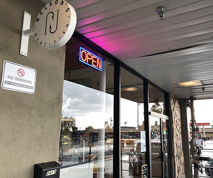 That sophisticated storefront with mood lighting suggests elevated fish house dining experiences ahead.