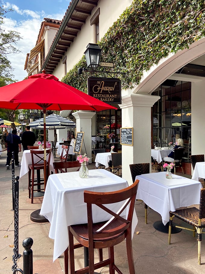 Red umbrellas and white tablecloths turn every pastry into a special occasion worth celebrating properly.