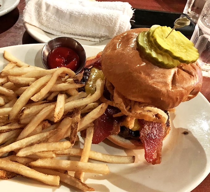 This burger isn't just wearing bacon like jewelry—it's embraced it as a lifestyle choice. The fries are just along for the glorious ride.