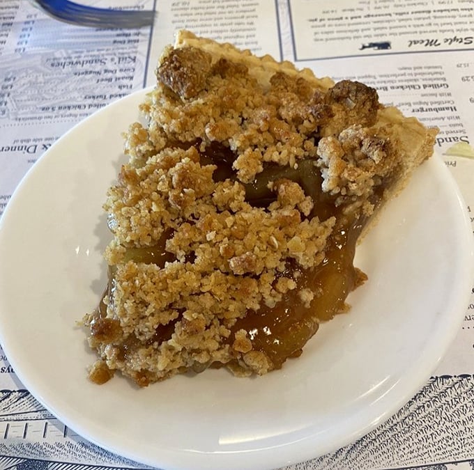 Apple pie with that perfect crumble topping—the kind that makes you consider ordering a second slice "for the road" before you've finished the first.