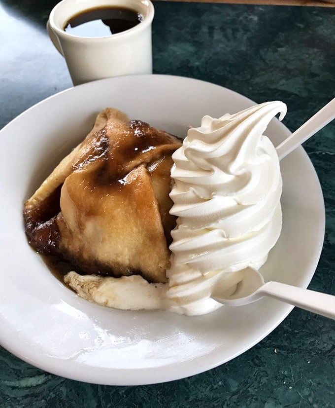 This apple dumpling with its cloud of whipped cream isn't dessert – it's what angels eat when nobody's looking. Coffee mandatory for the full experience.