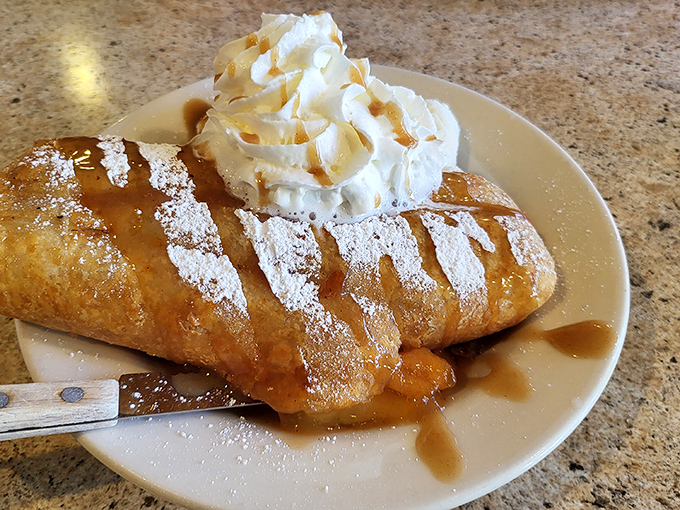 Apple pie that deserves its own zip code. That caramel drizzle and whipped cream topping aren't just garnishes—they're essential supporting characters in this dessert drama.