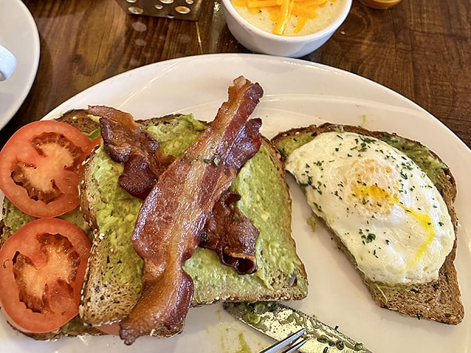 Avocado toast that Instagram was invented for—perfectly jammy egg, crispy bacon, and that avocado spread that somehow makes healthy eating feel like cheating.