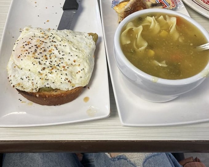 Simple pleasures done right – a perfectly fried egg atop hearty toast alongside homemade soup that warms you from the inside out.
