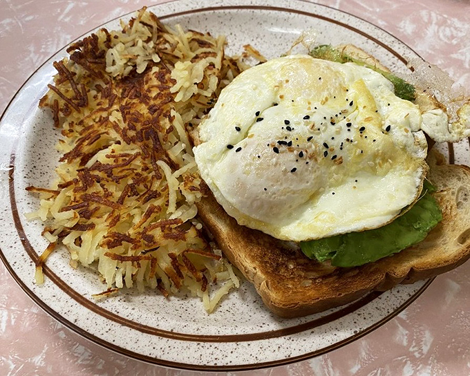 Avocado toast that doesn't require a second mortgage, topped with an egg that's sunny-side up – just like your mood will be after eating it.