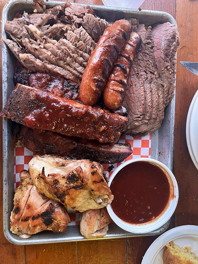 This BBQ combo platter is the United Nations of meat—bringing together ribs, brisket, chicken, and sausage in delicious diplomatic relations.