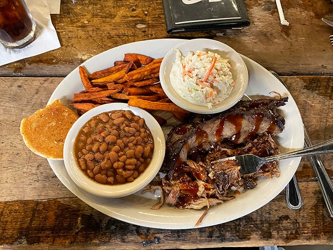 BBQ that respects tradition while creating its own – tender pulled pork alongside baked beans and slaw on a plate that's basically Tennessee's greatest hits album.