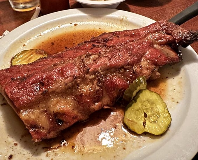 Baby back ribs swimming in their own juices—the kind of plate that makes conversation impossible except for occasional grunts of approval.