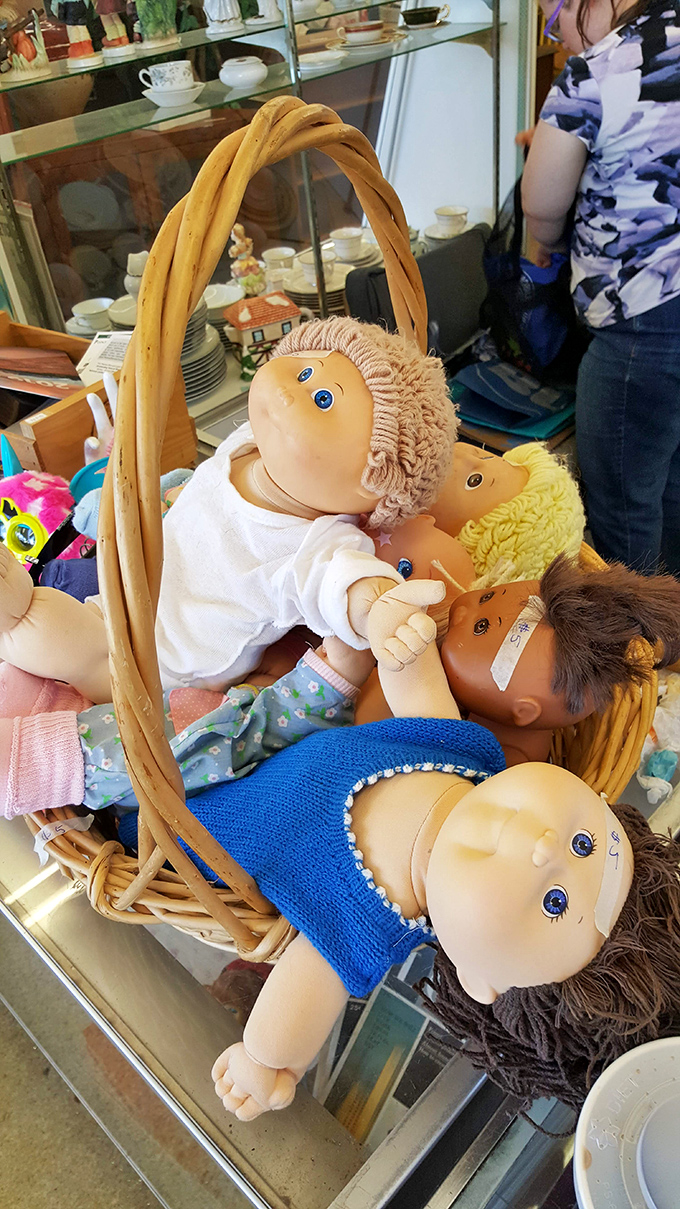 Cabbage Patch Kids' distant cousins gather in this wicker basket, their hopeful plastic eyes searching for new homes and imaginary adventures.