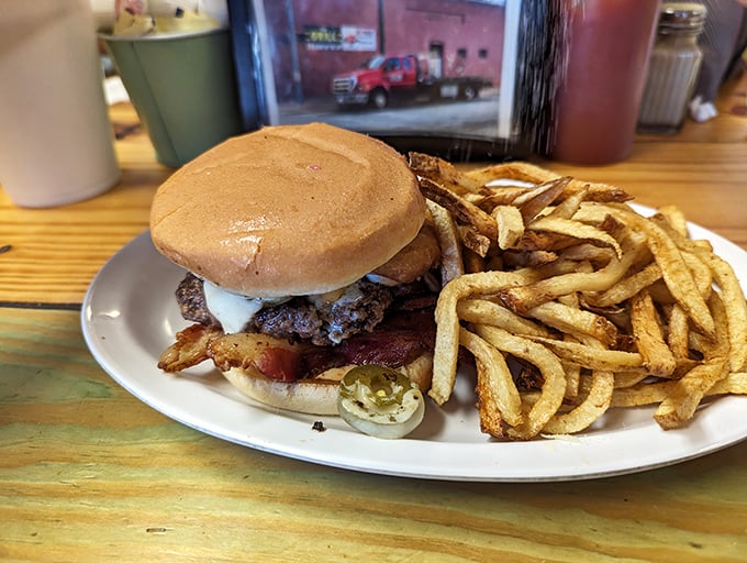 Sweet potato fries and a bacon cheeseburger—the culinary equivalent of finding money in an old jacket pocket. Unexpected joy on a black plate.