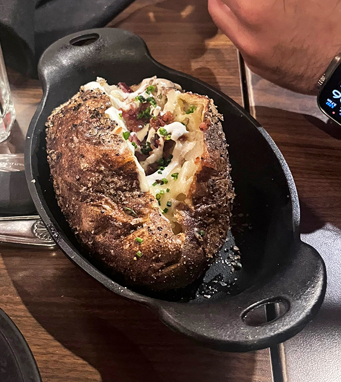 That baked potato isn't just a side—it's a masterpiece of butter, bacon, and cheese that deserves its own spotlight.